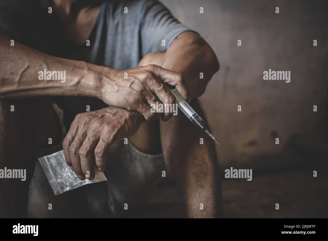 Human hand of a drug addict and a syringe with narcotic syringe lying ...