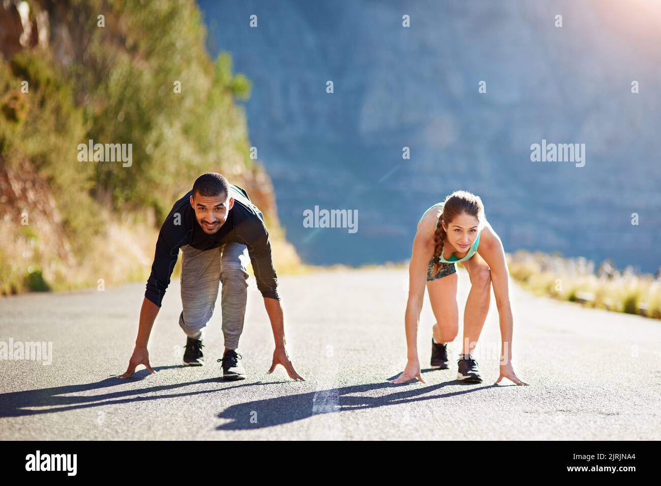 Racing towards their fitness goals. a sporty young couple on their mark ...