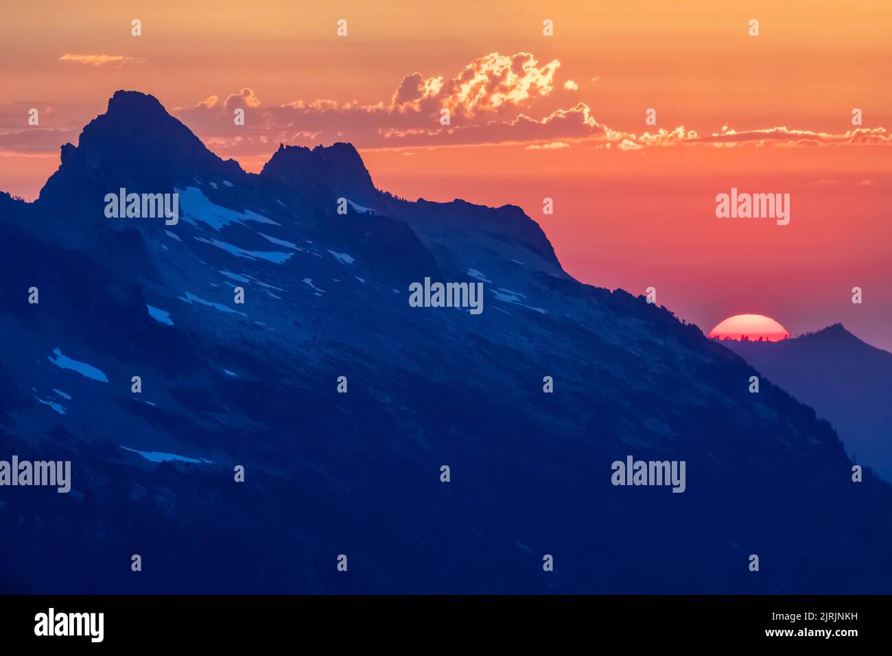 Smoky sunset over the mountains viewed from Evergreen Mountain Lookout ...