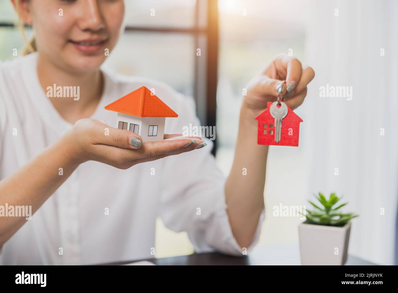 Your new house, real estate agent holding house key to his client after ...