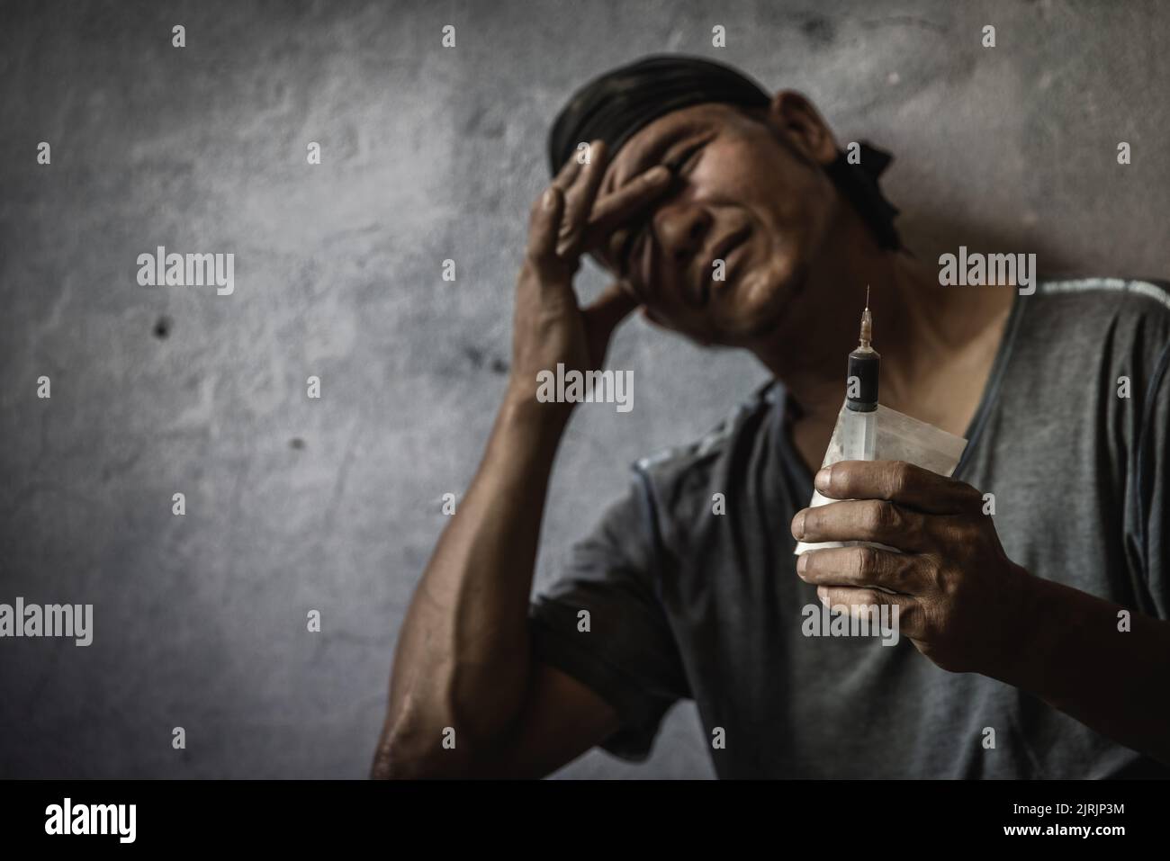 A man who is addicted to carrying heroin and syringe in his hand ...