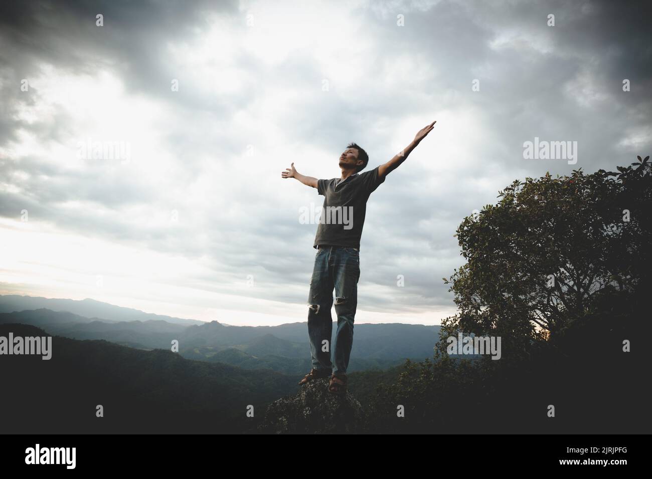 Man praying on the mountains raised hands Travel Lifestyle spiritual ...