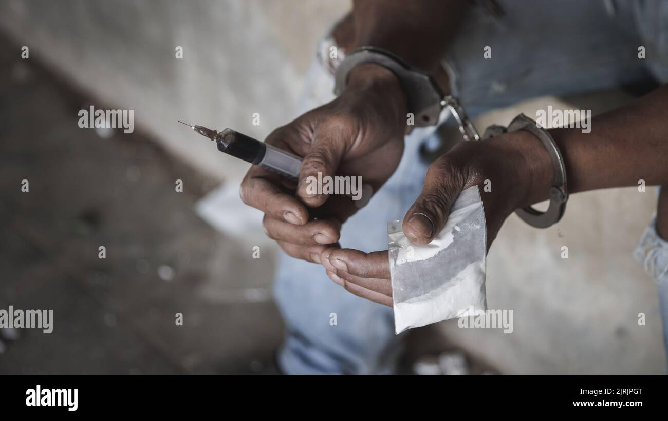 Drug dealer under arrest confined with handcuffs. Anti drug. Drug ...