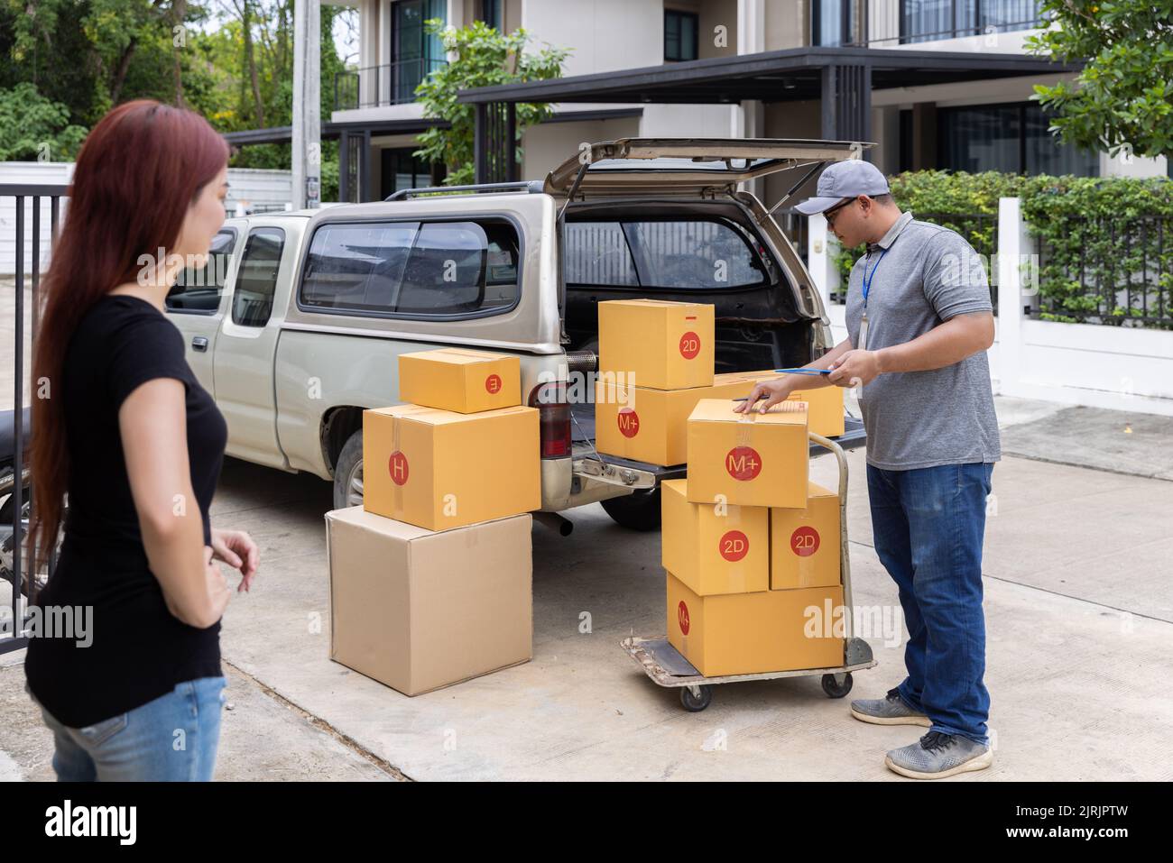 The courier checks the goods before delivering them to the homeowner ...