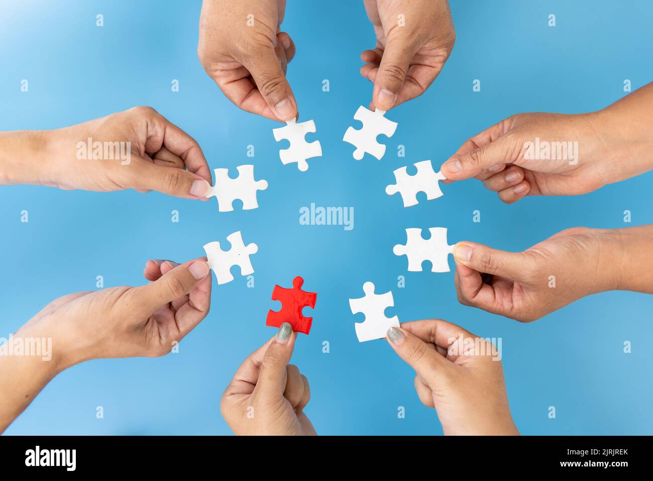 people helping in assembling puzzle, cooperation in decision making ...