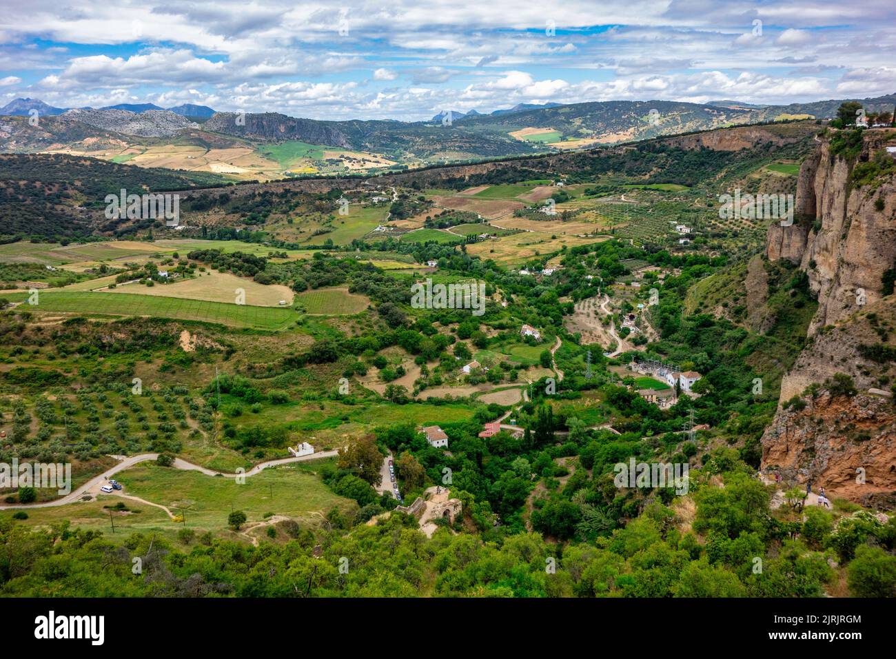 An aerial view of a green valley from the city of Ronda in Spain in ...