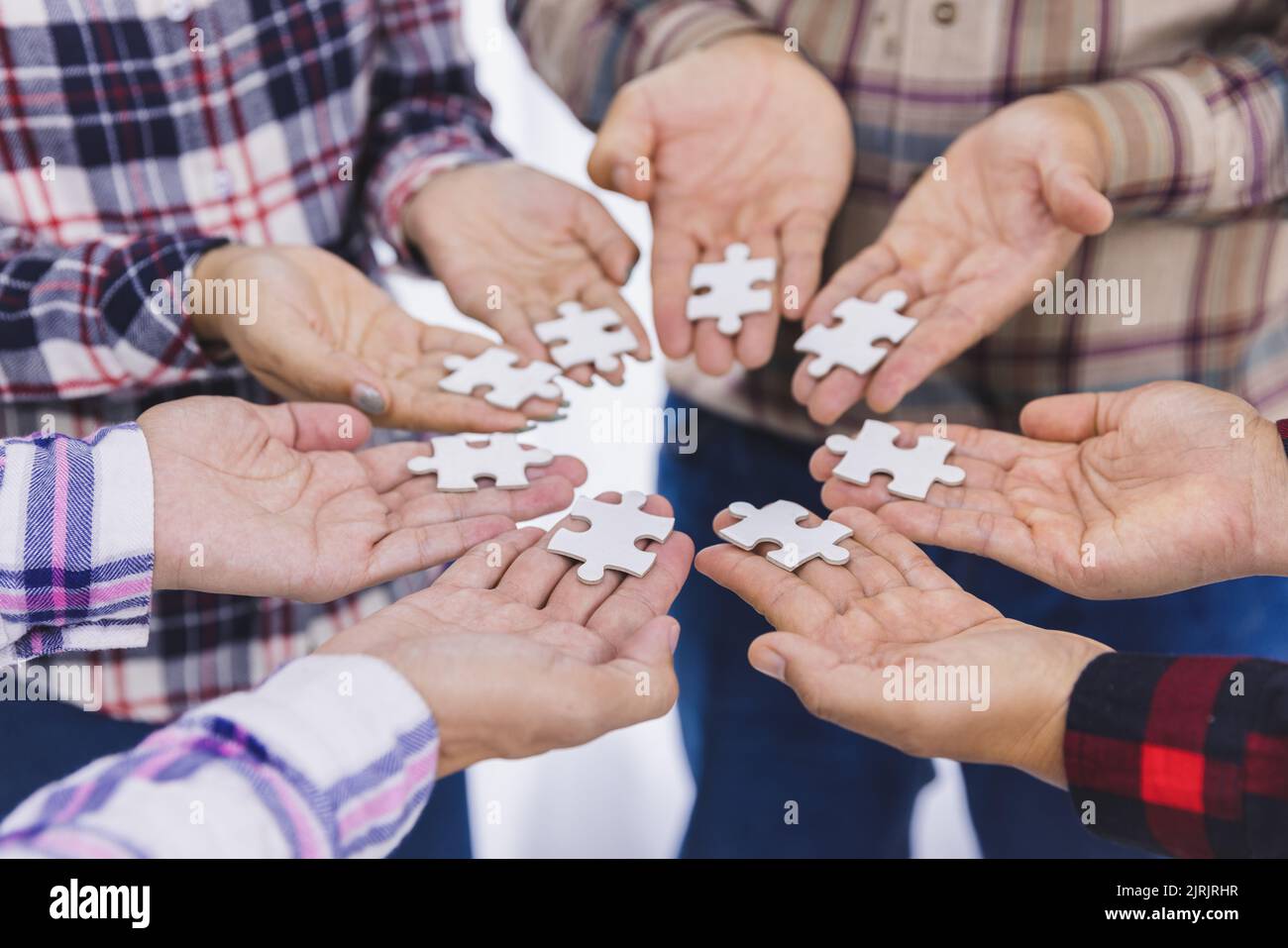 people helping in assembling puzzle, cooperation in decision making ...