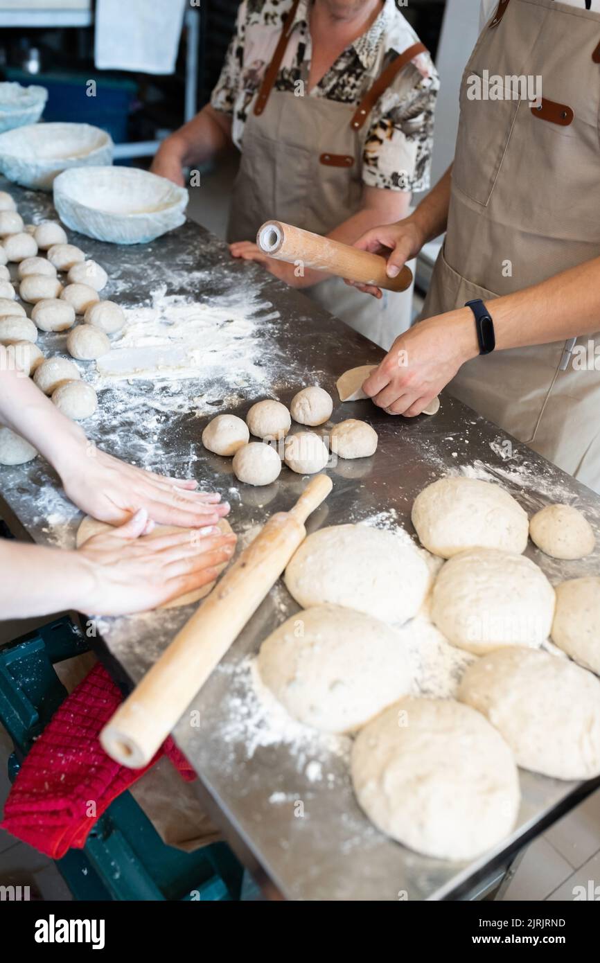 The process of learning the craft of baking in a small bakery, molding ...