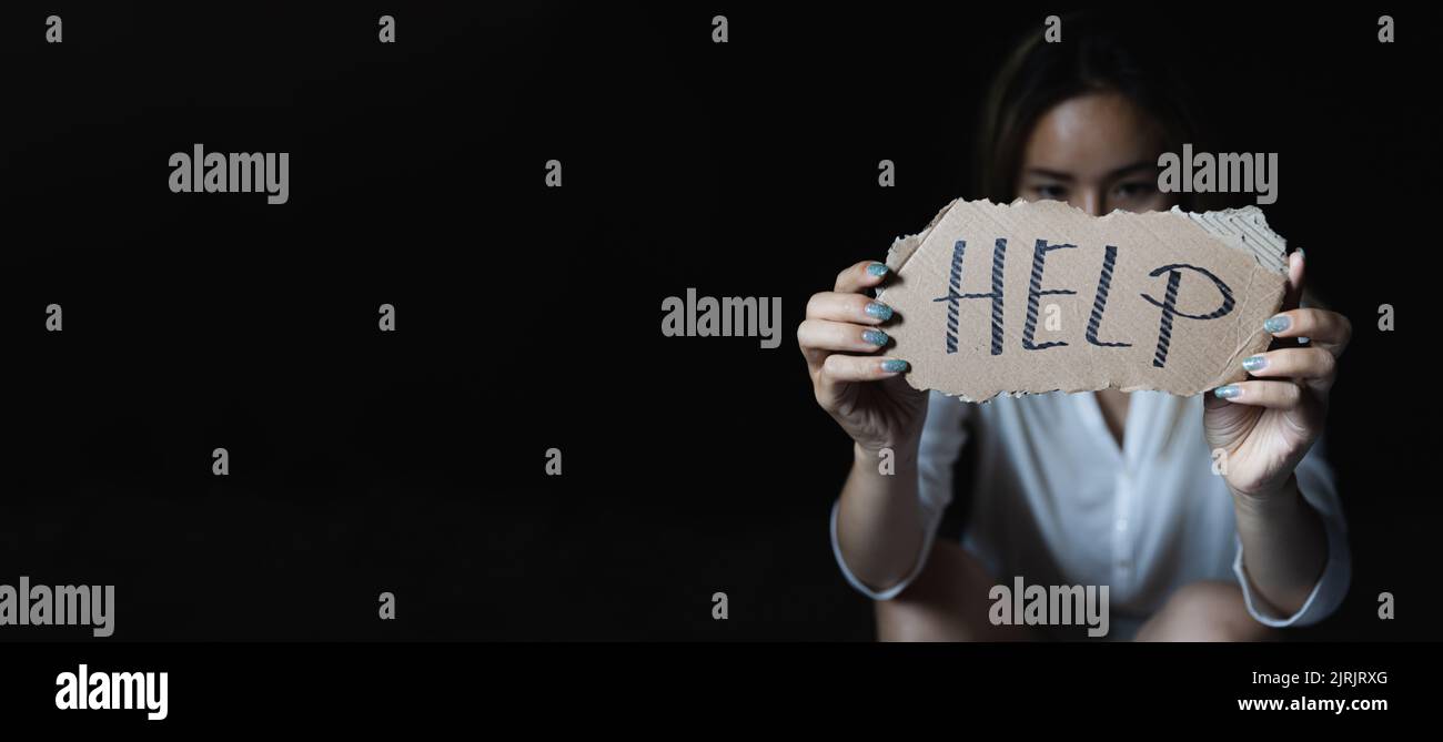 Women sitting alone with depressed expression and showing a paper with ...