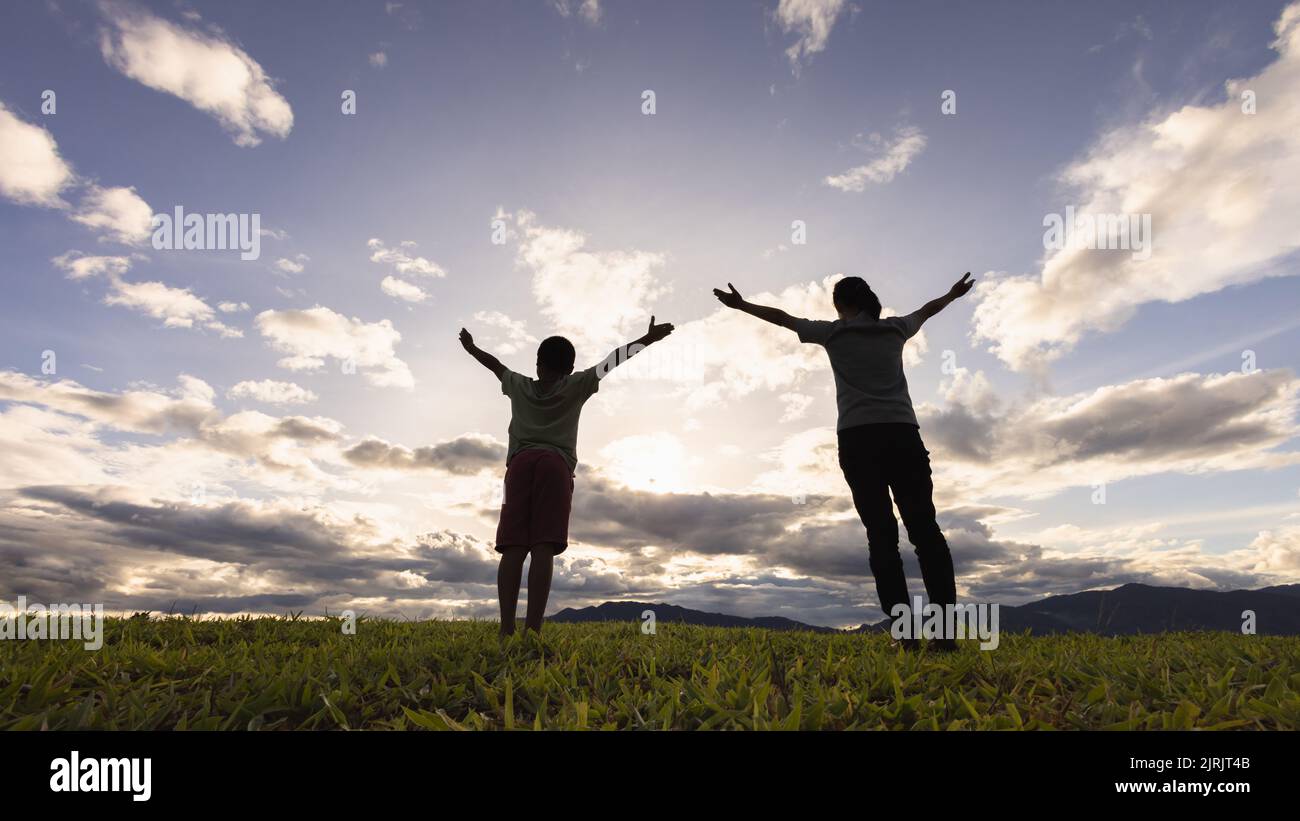 little boy with his mother Raise your hand to pray for God's blessing ...