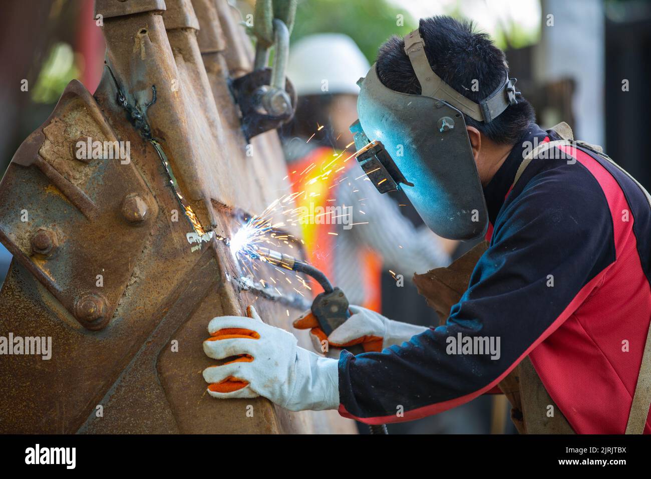 Specialist welder weld construction frame, welding spark , Welder is welding metalwork ...