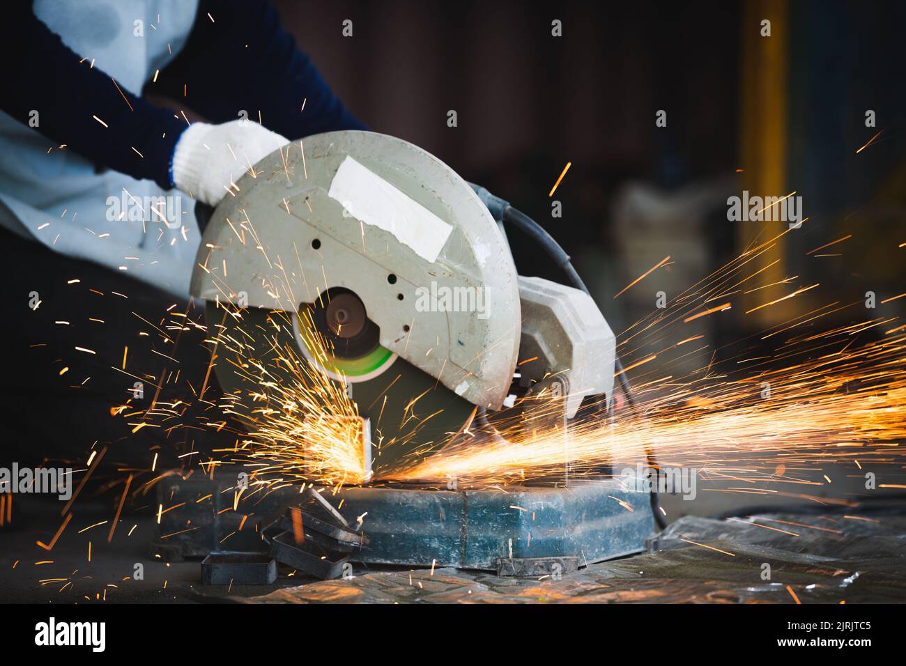 Cutting of a steel with splashes of sparks. Steel industry and workshop ...