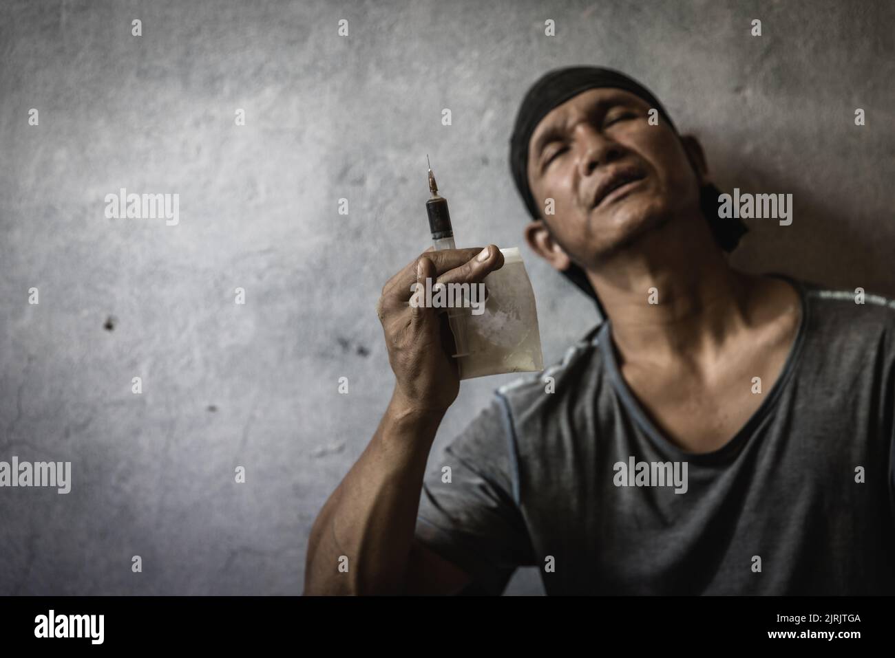 Drug addict young man with syringe in action, Drug abuse concept Stock ...