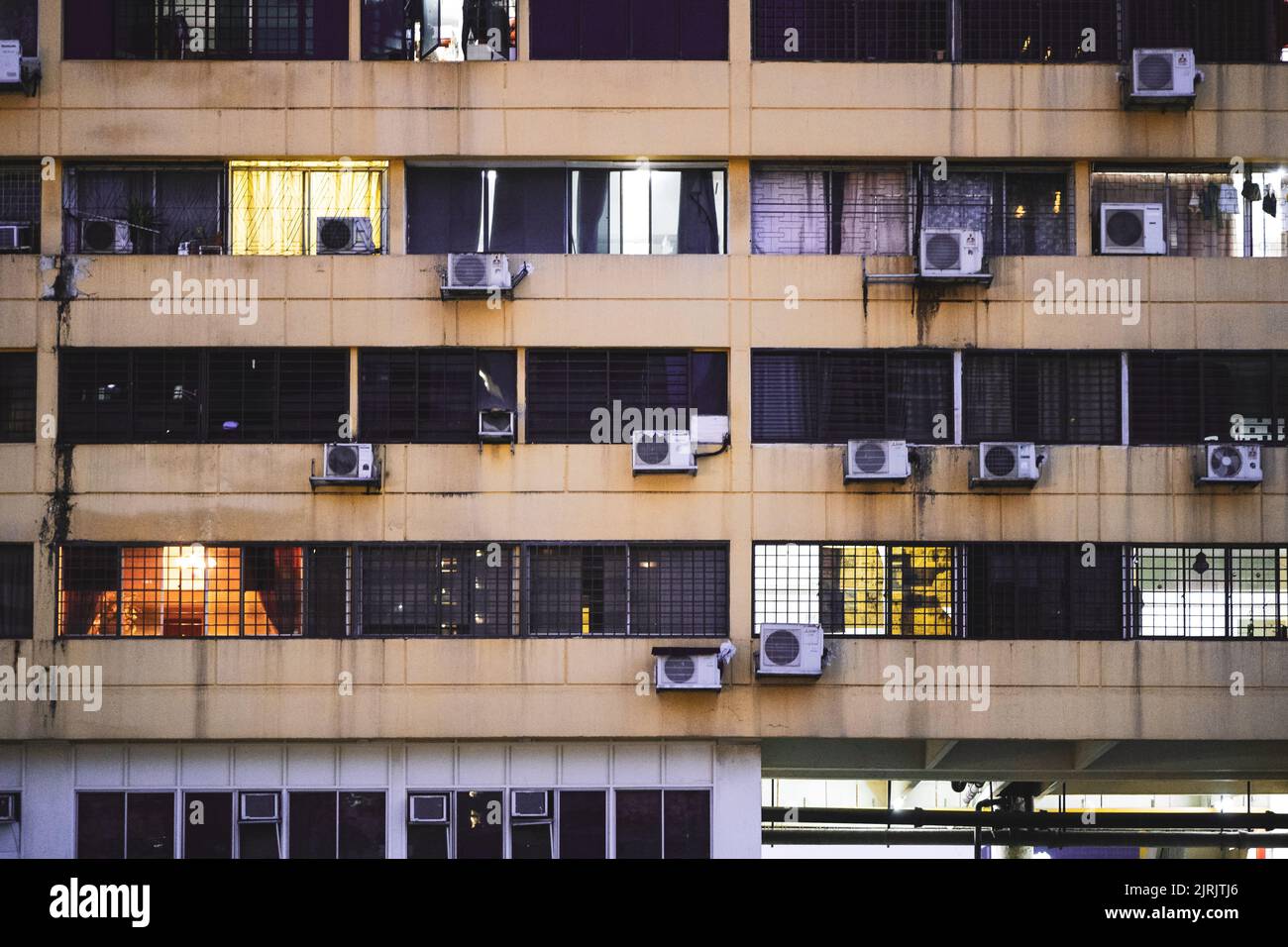 An exterior view of rows of windows of an old residential building ...