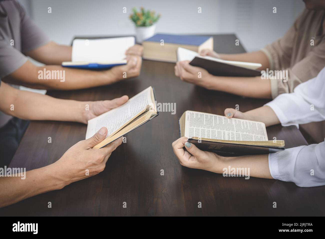 Young woman praying among other religious people indoors. Religious ...