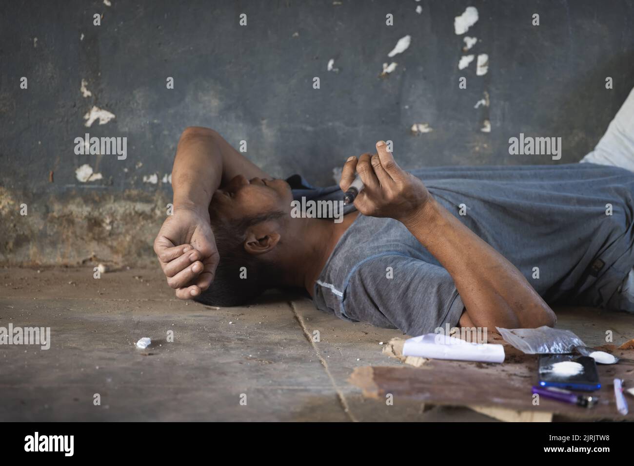 Human hand of a drug addict and a syringe with narcotic syringe lying ...