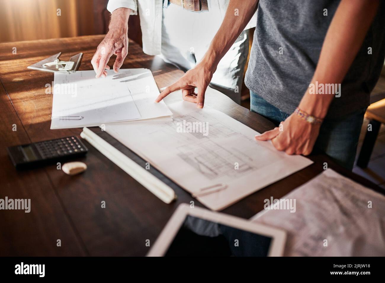 Everything is coming together nicely. two unrecognizable men working on ...