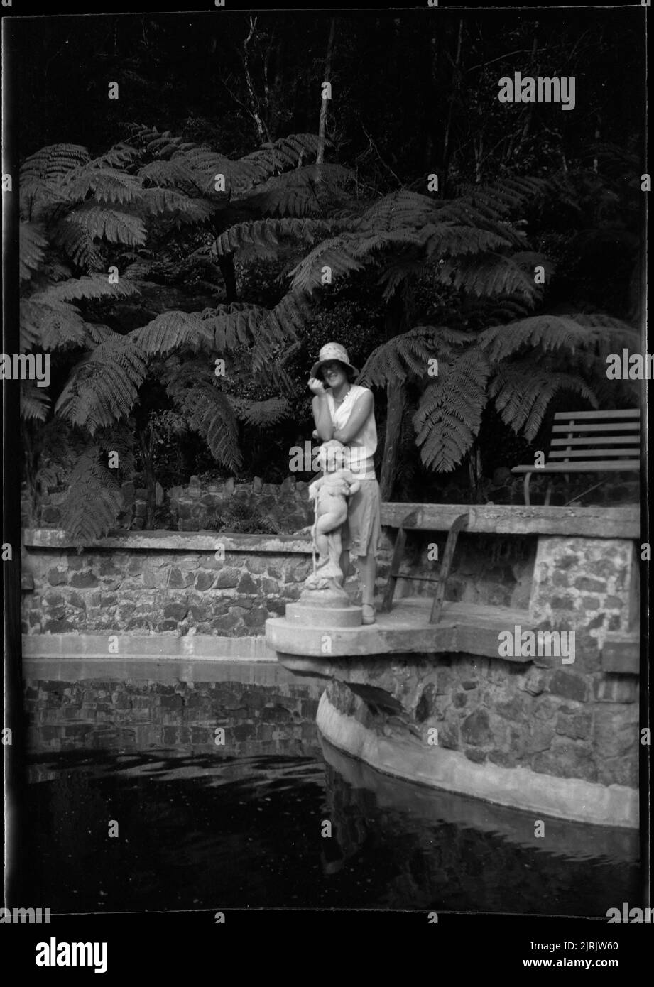 [Woman leaning on statue], 1920s to 1930s, by Roland Searle Stock Photo ...