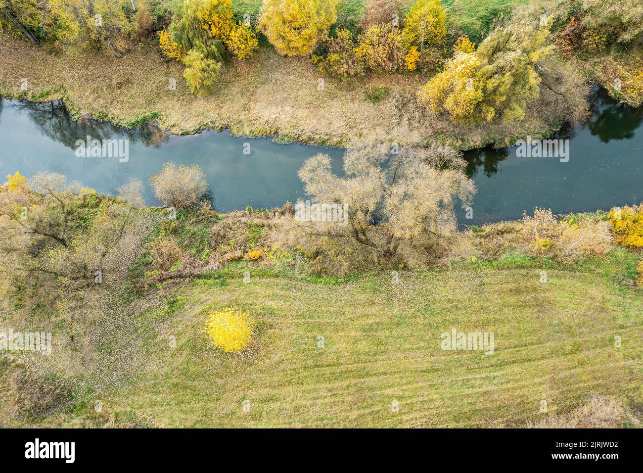 autumn river scenery with colorful trees on meadow. aerial top view ...