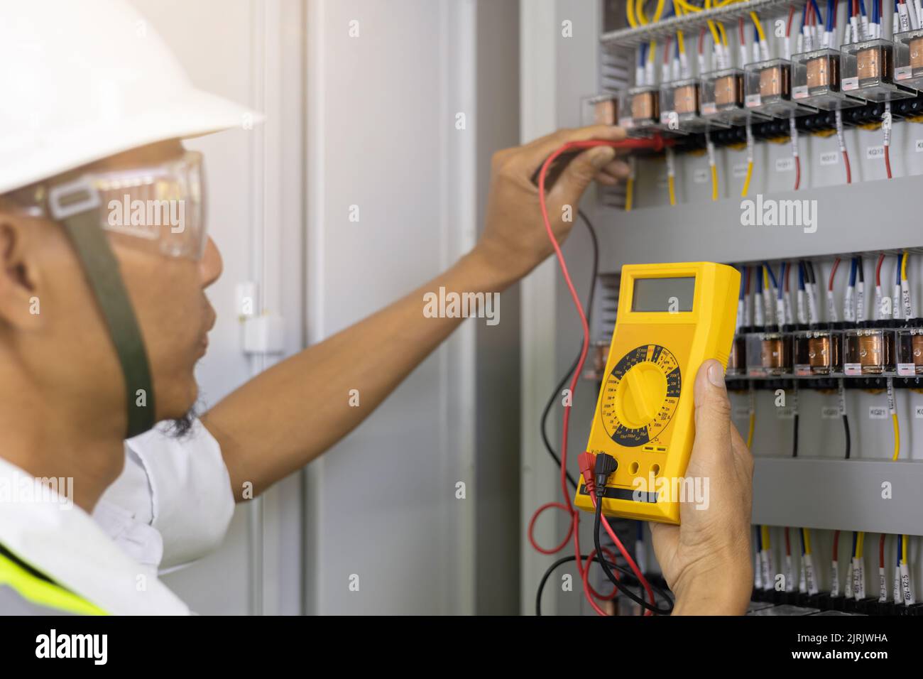Electrician engineer work tester measuring voltage and current of power ...