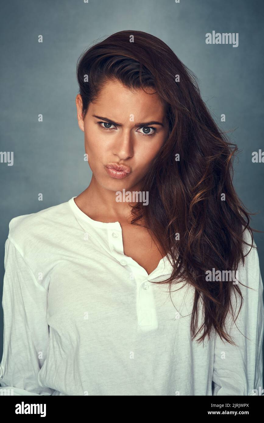 Ive got my eye on you. Portrait of a beautiful young woman pulling a ...