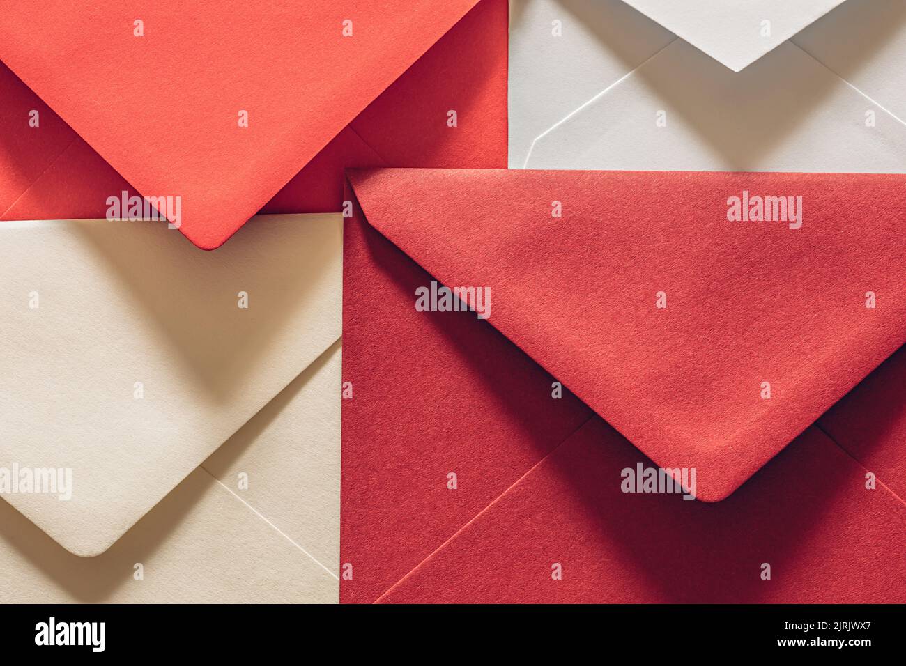 Different sizes and colors of textured paper open postal envelopes as a ...