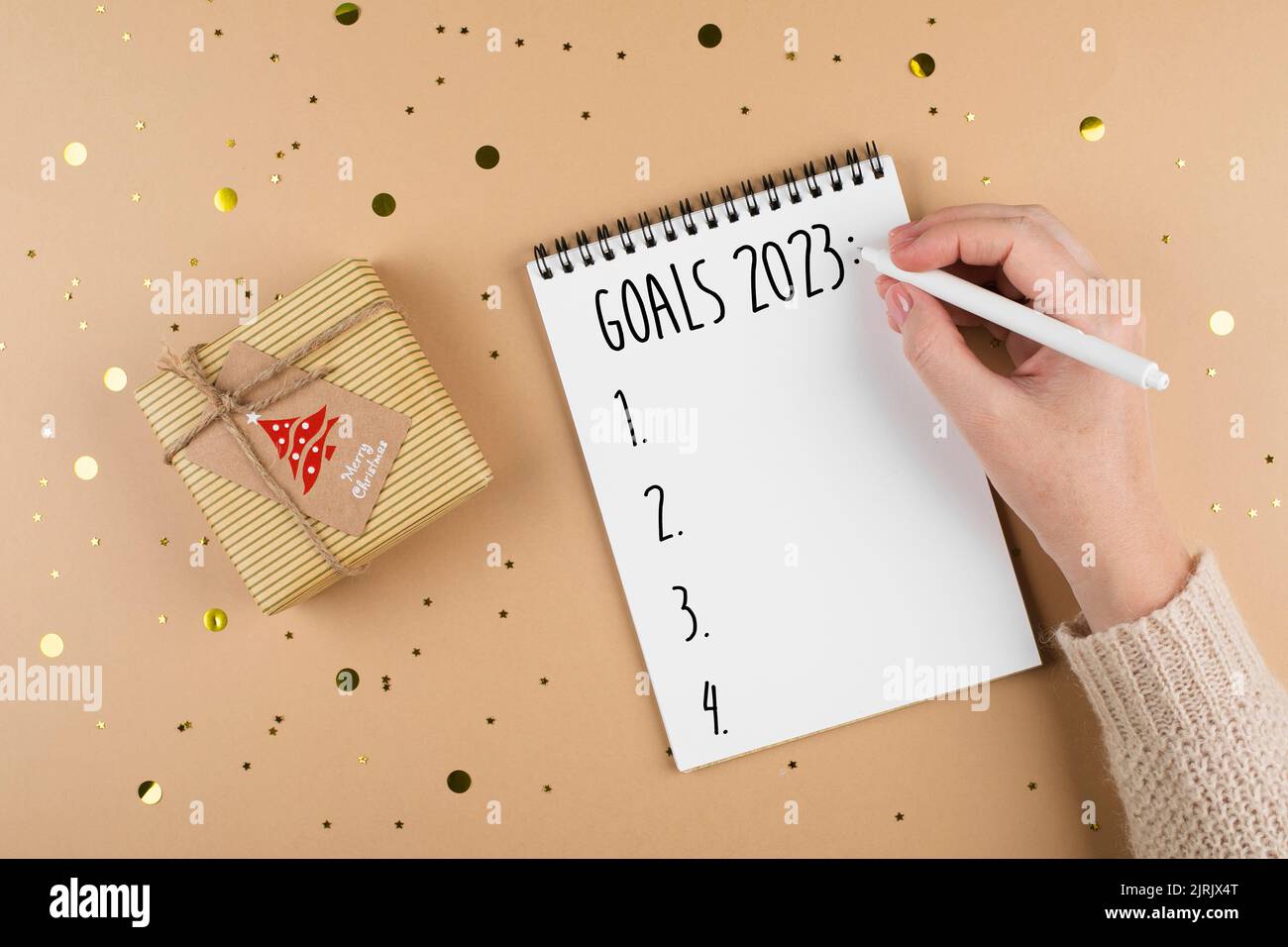 New Year goals 2023. Woman's hand writing in note pad goals list ...