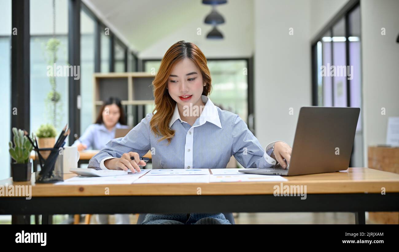 Beautiful and attractive Asian businesswoman or female financial ...