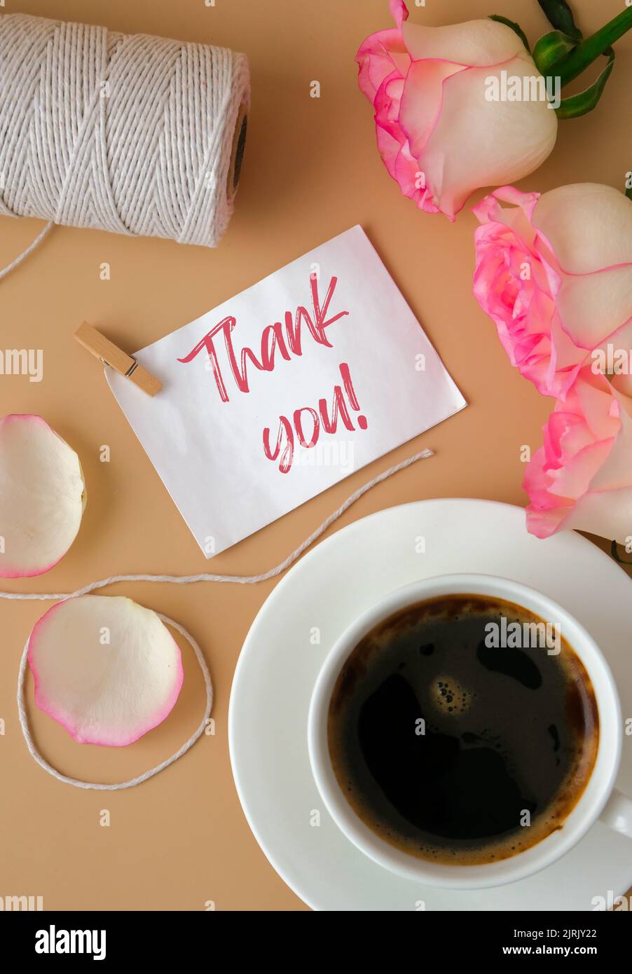 THANK YOU text Tender pink rose with white cup of coffee on beige ...
