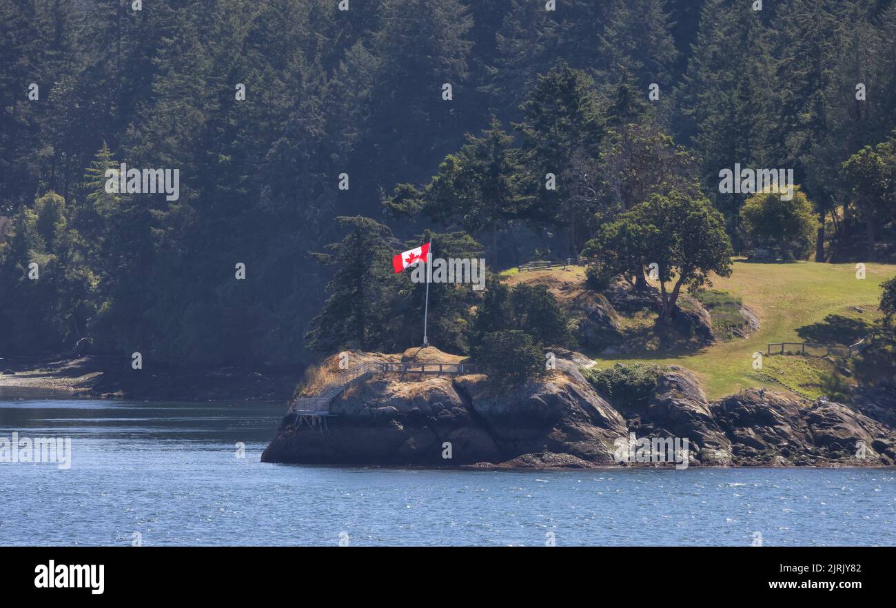 Canadian Flag and Landscape by the ocean. Summer Season Stock Photo - Alamy