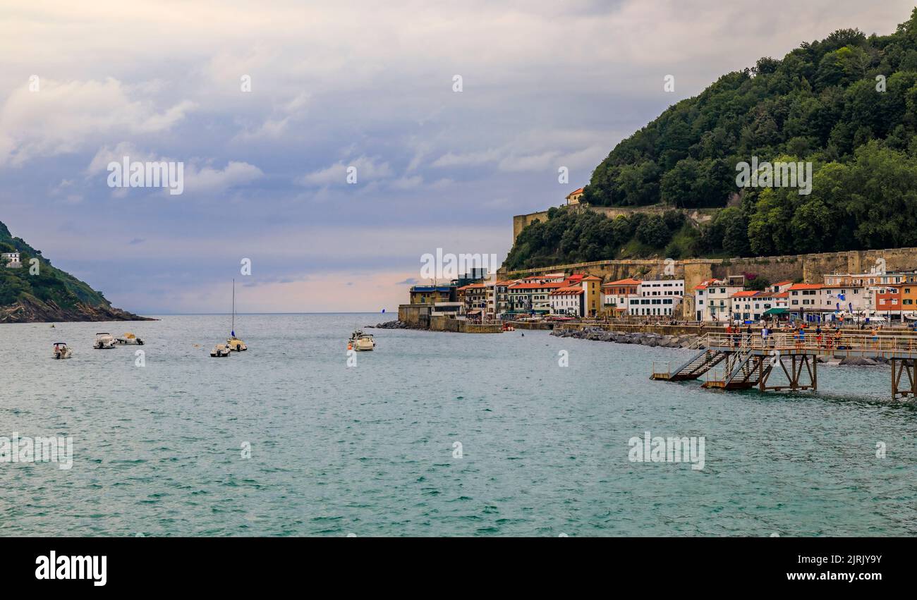La Concha bay and beach with the mount Urgull and waterfront houses in ...