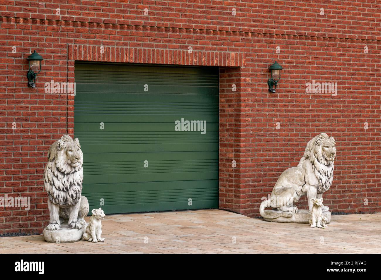 green gate of a brick building guarded by lion statues Stock Photo - Alamy