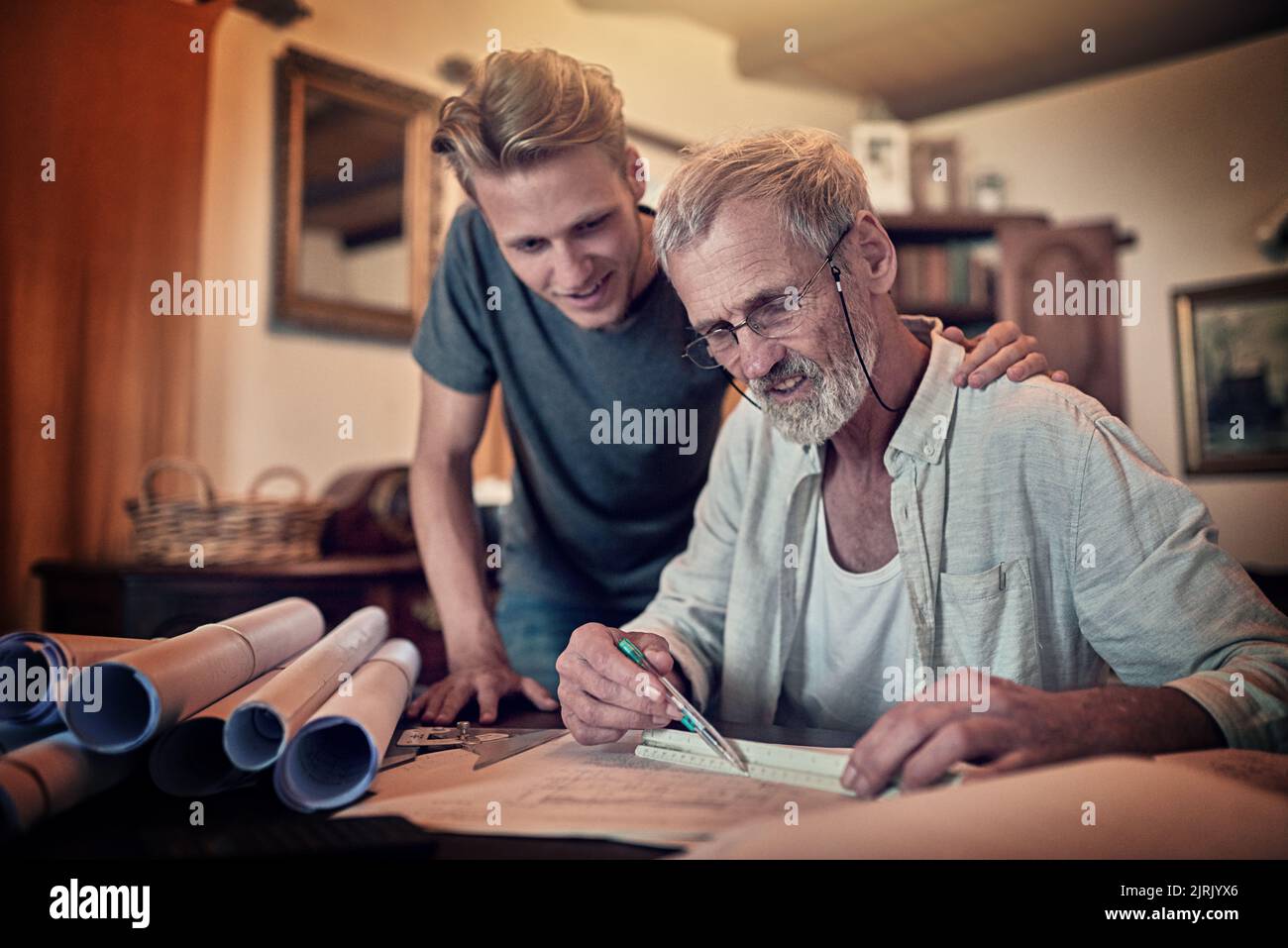 Two minds are better than one. a father and his son working on a design ...