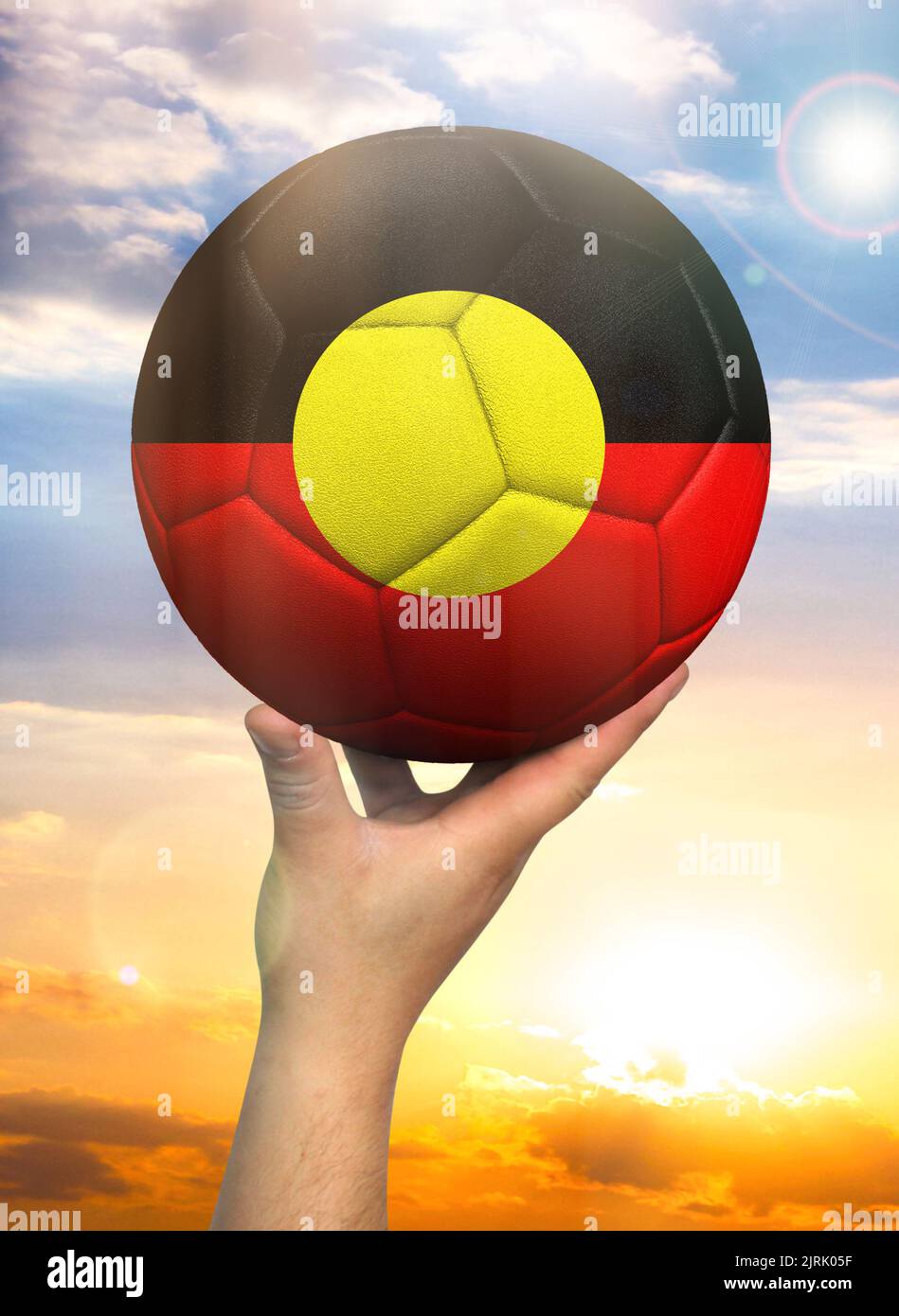 Soccer ball in hand with a depiction of the flag of Australian ...