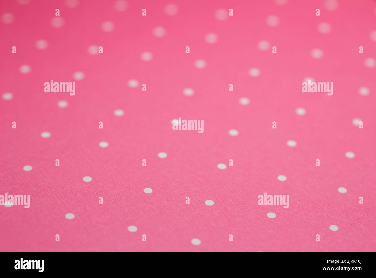 Full frame abstract texture background of solid pink and white polka ...