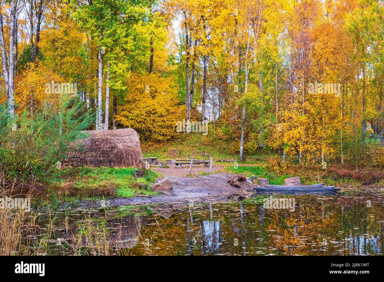 Huts at a the lakeshore with dugouts canoes a beautiful autumn day ...