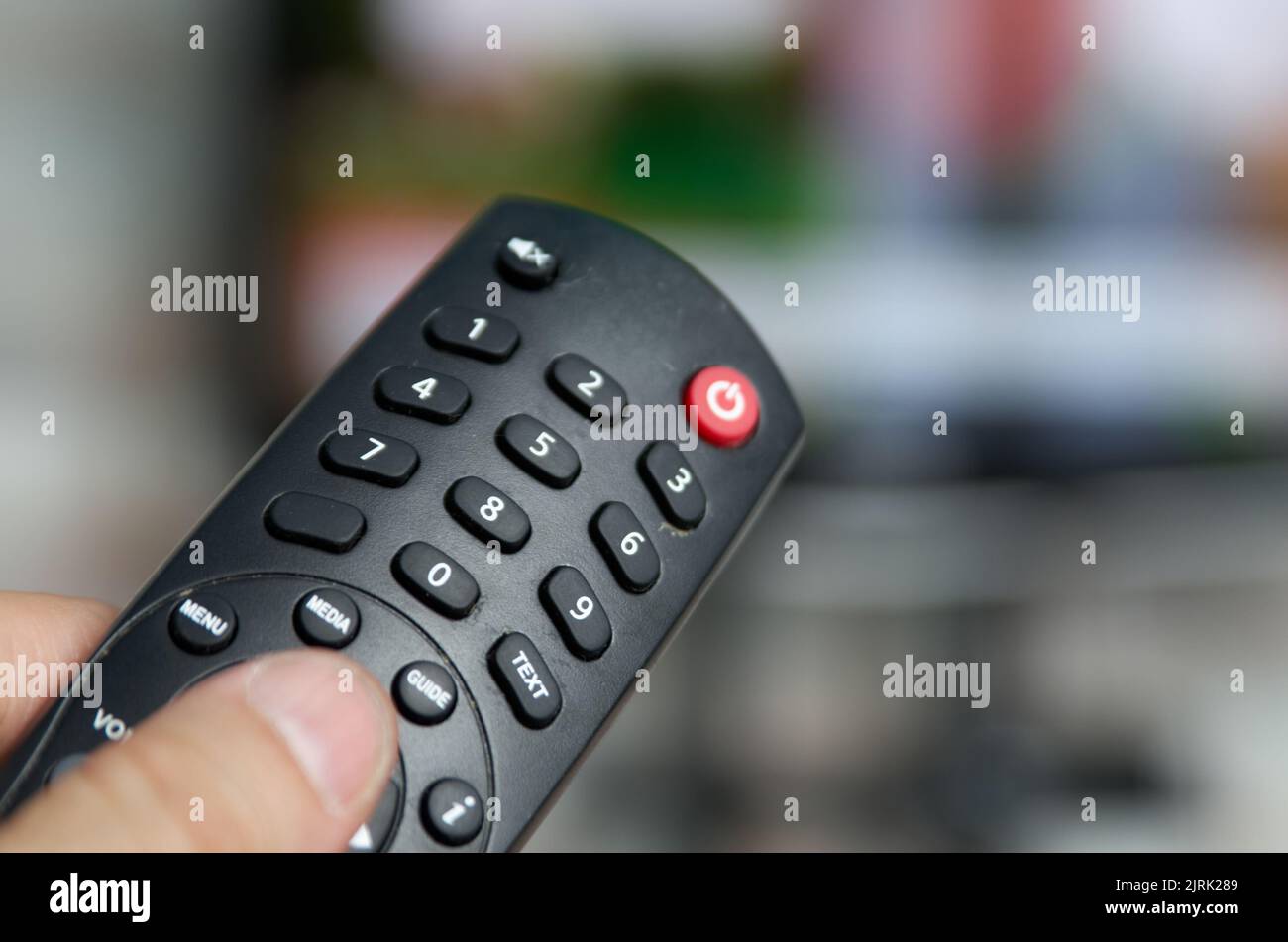Changing TV program: close up of human hand holding television remote ...