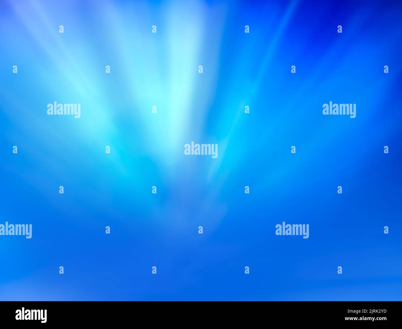 Holiday heavenly light radiance on blue sky background. Abstract pastel ...