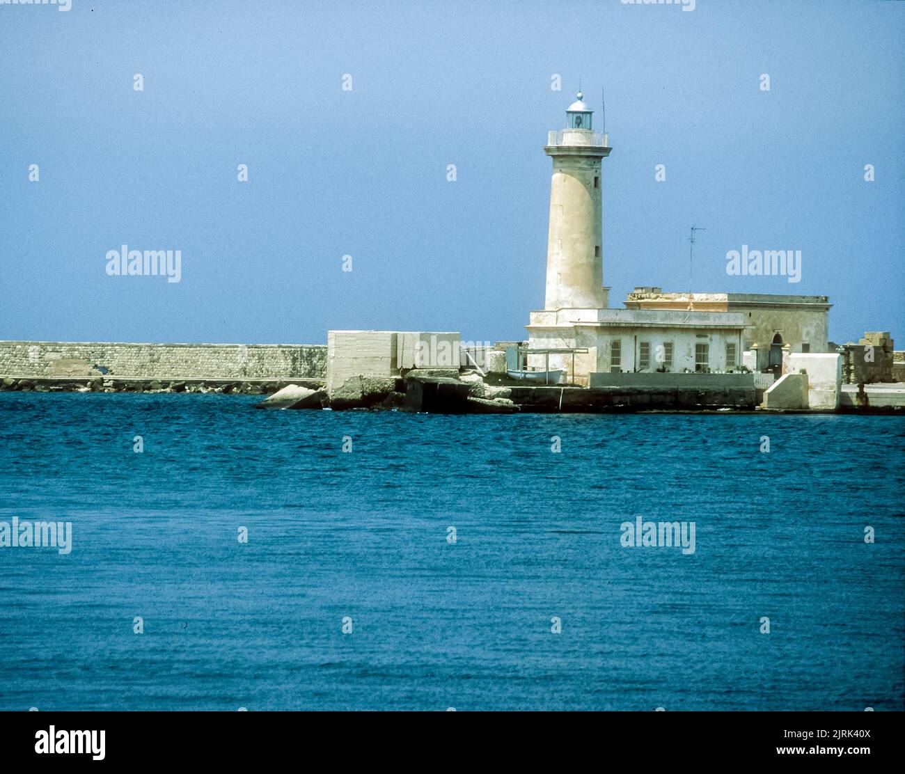 A lighthouse provides guidance at the entrance to the port of Marsala ...