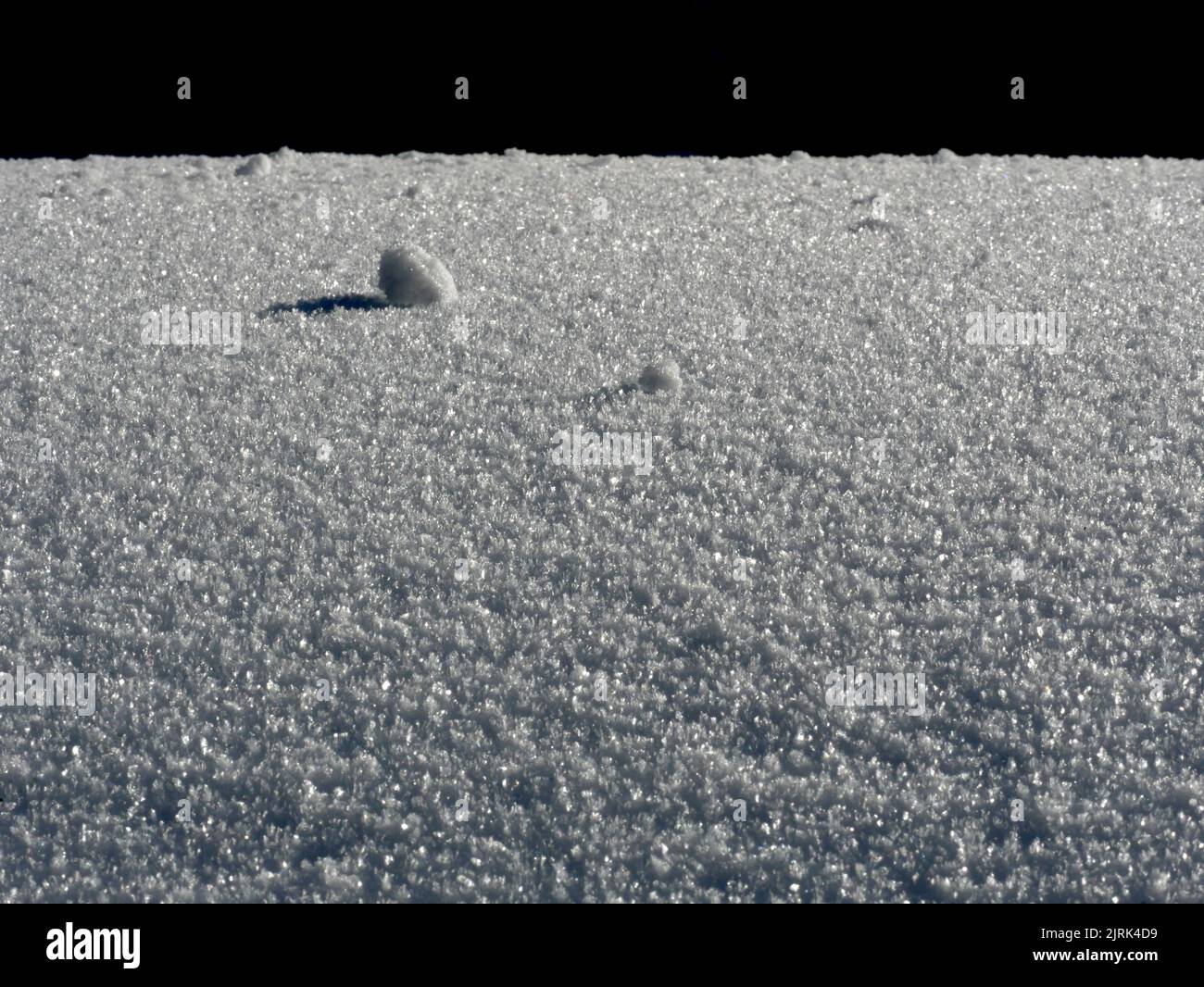snow ball on a white snow layer with large frost ice crystals Stock ...