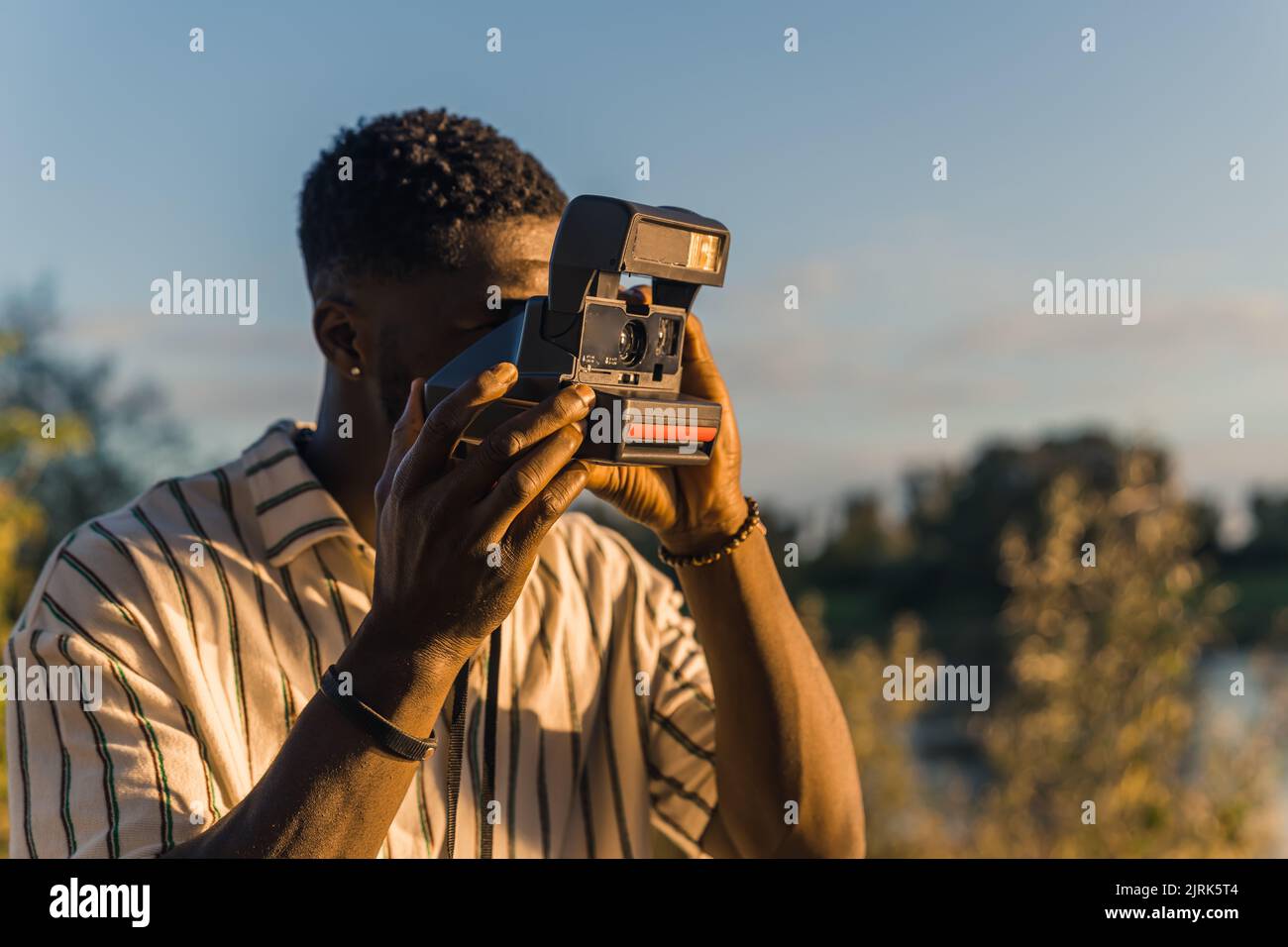 Young serene male photographer-amateur snapping photos of the ...