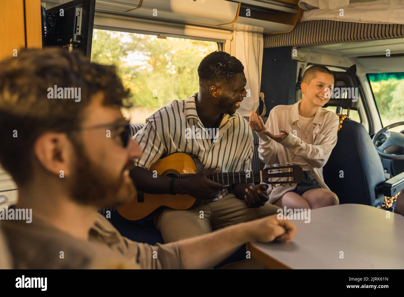 Multi-ethnic group of close friends on a summer road trip in a camping ...