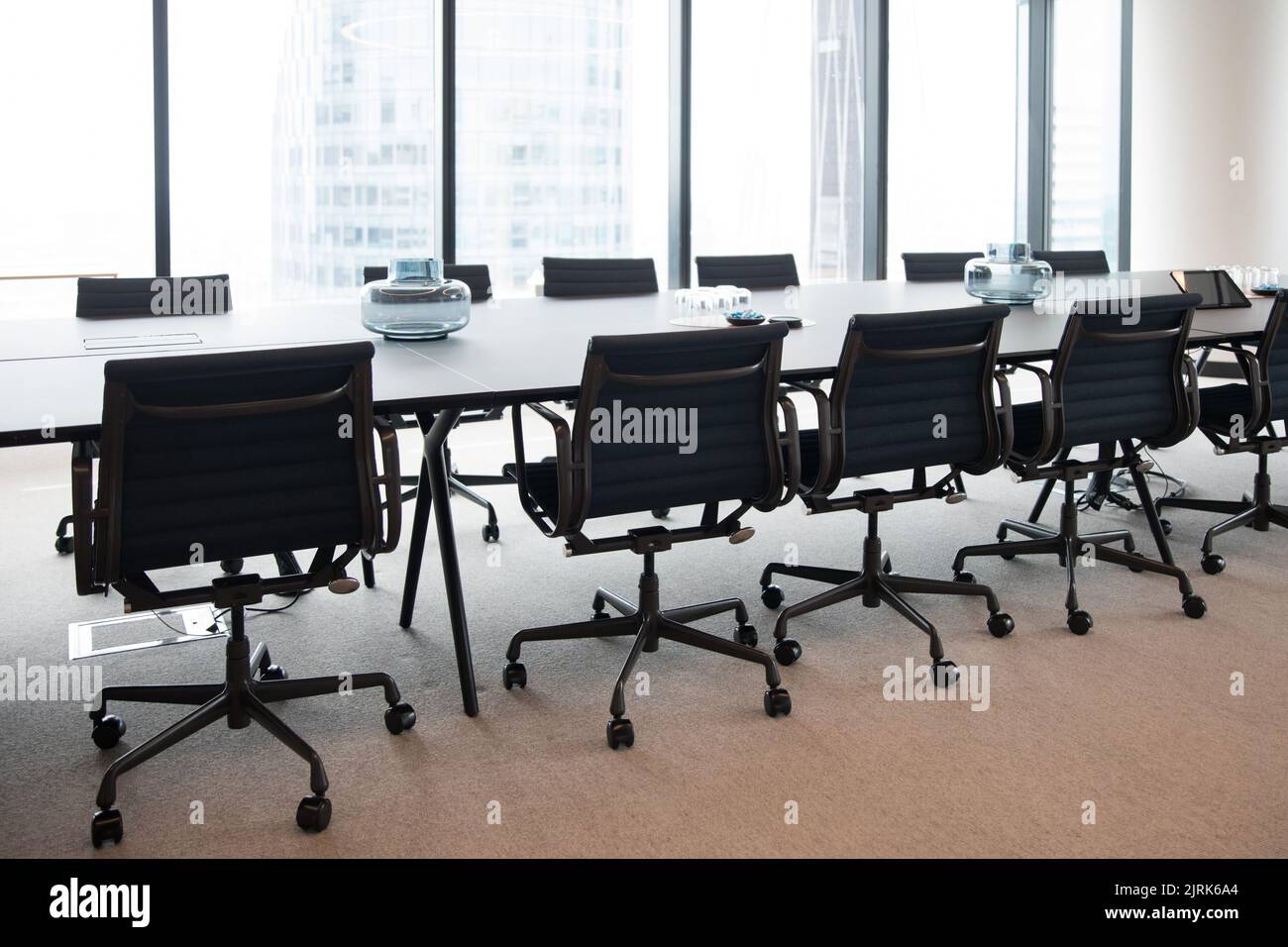 A modern interior design for an office with a long table and chairs ...