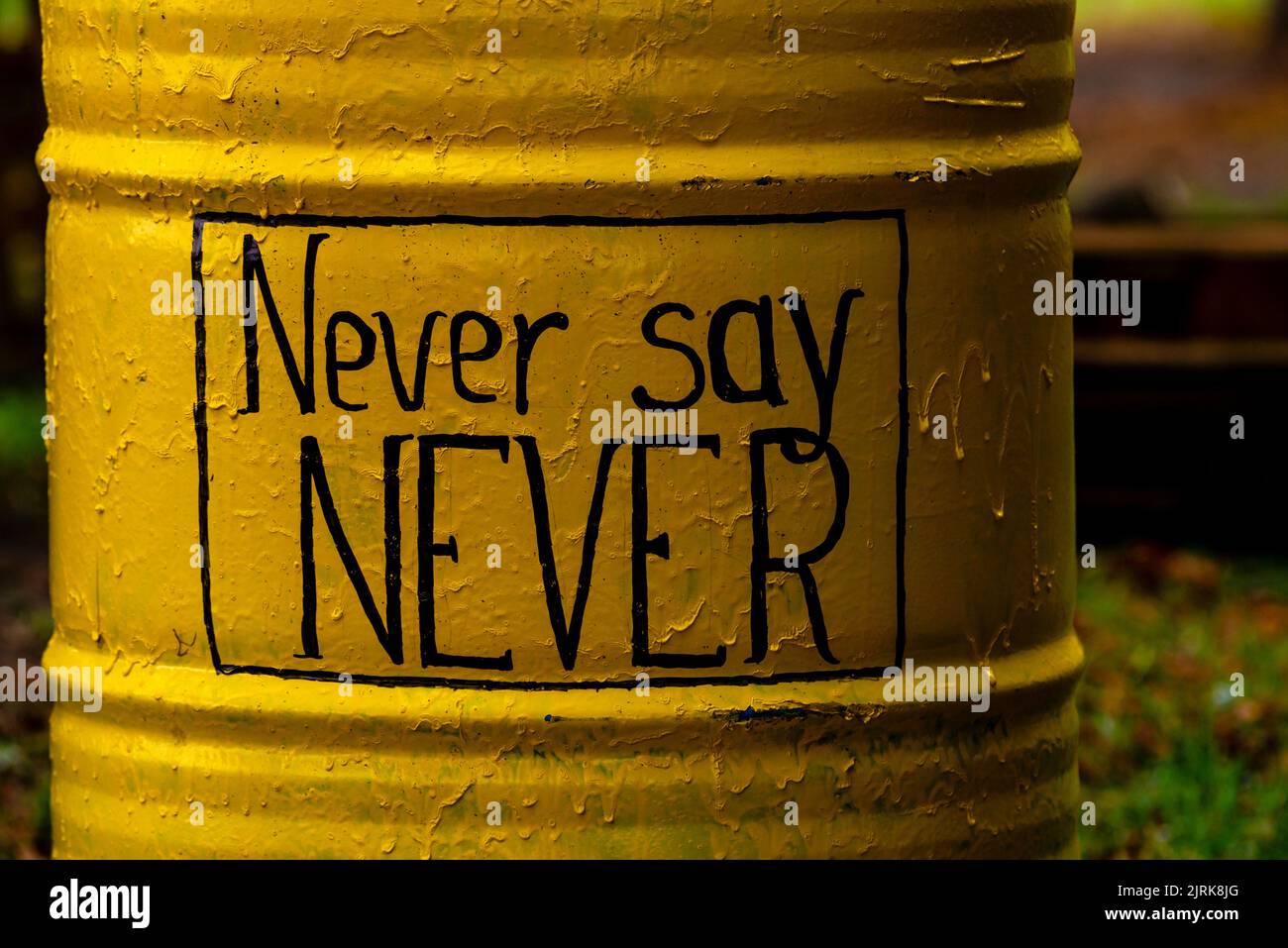 metal barrel painted yellow never say never wordd concept message card ...