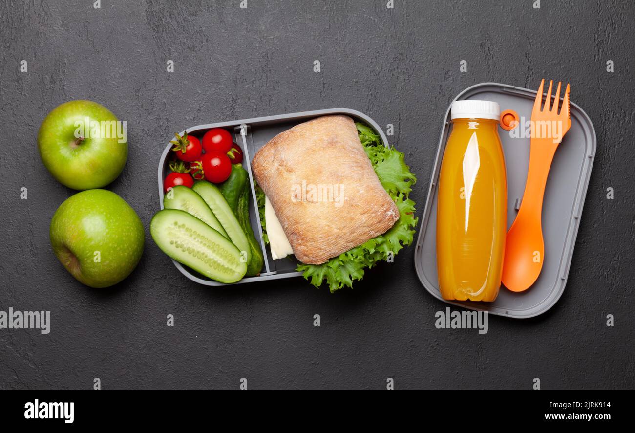 Lunch box with sandwich, vegetables and juice. School or office meal ...