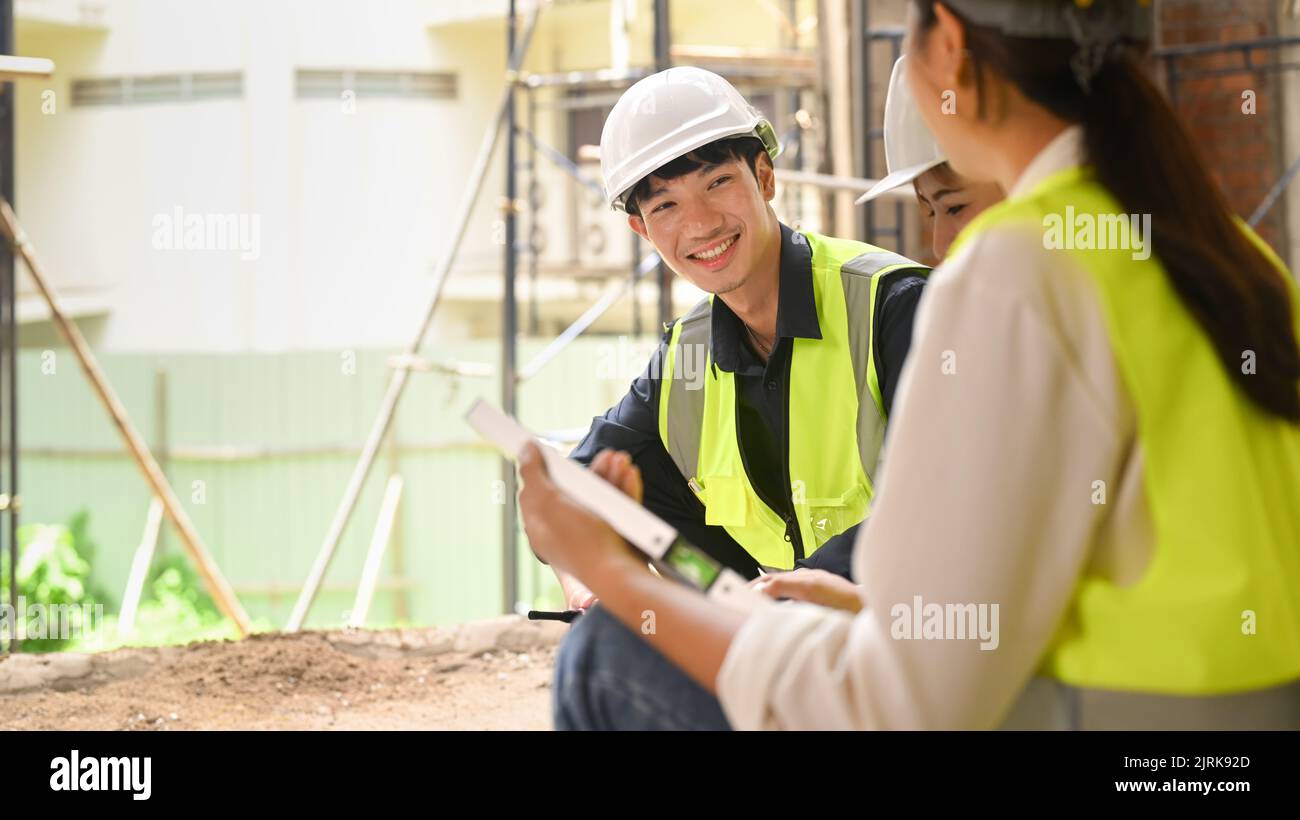 Man engineer supervisor and architect wearing safety helmets discussing ...