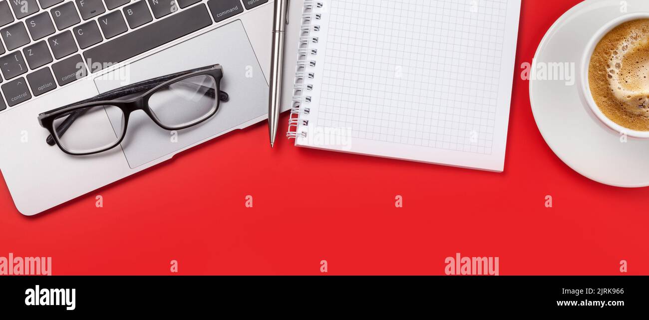 Office red workplace backdrop with coffee cup, supplies and computer ...