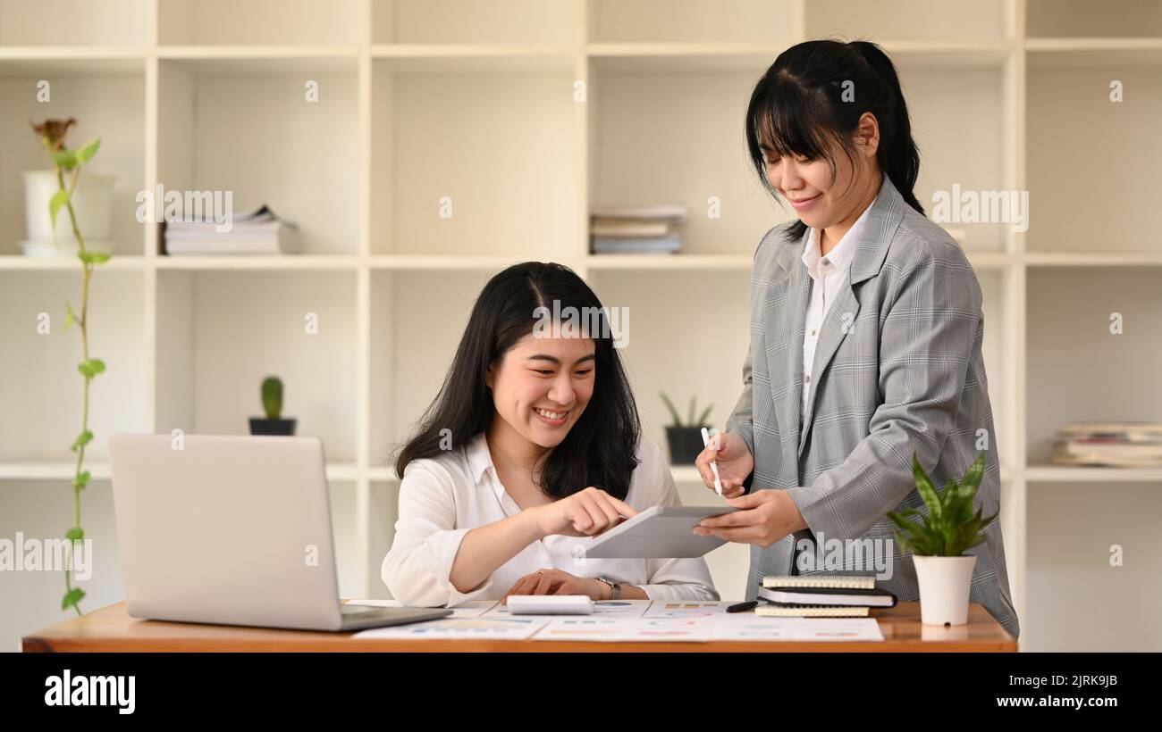 Asian female manager giving advice, discussing new marketing strategy ...
