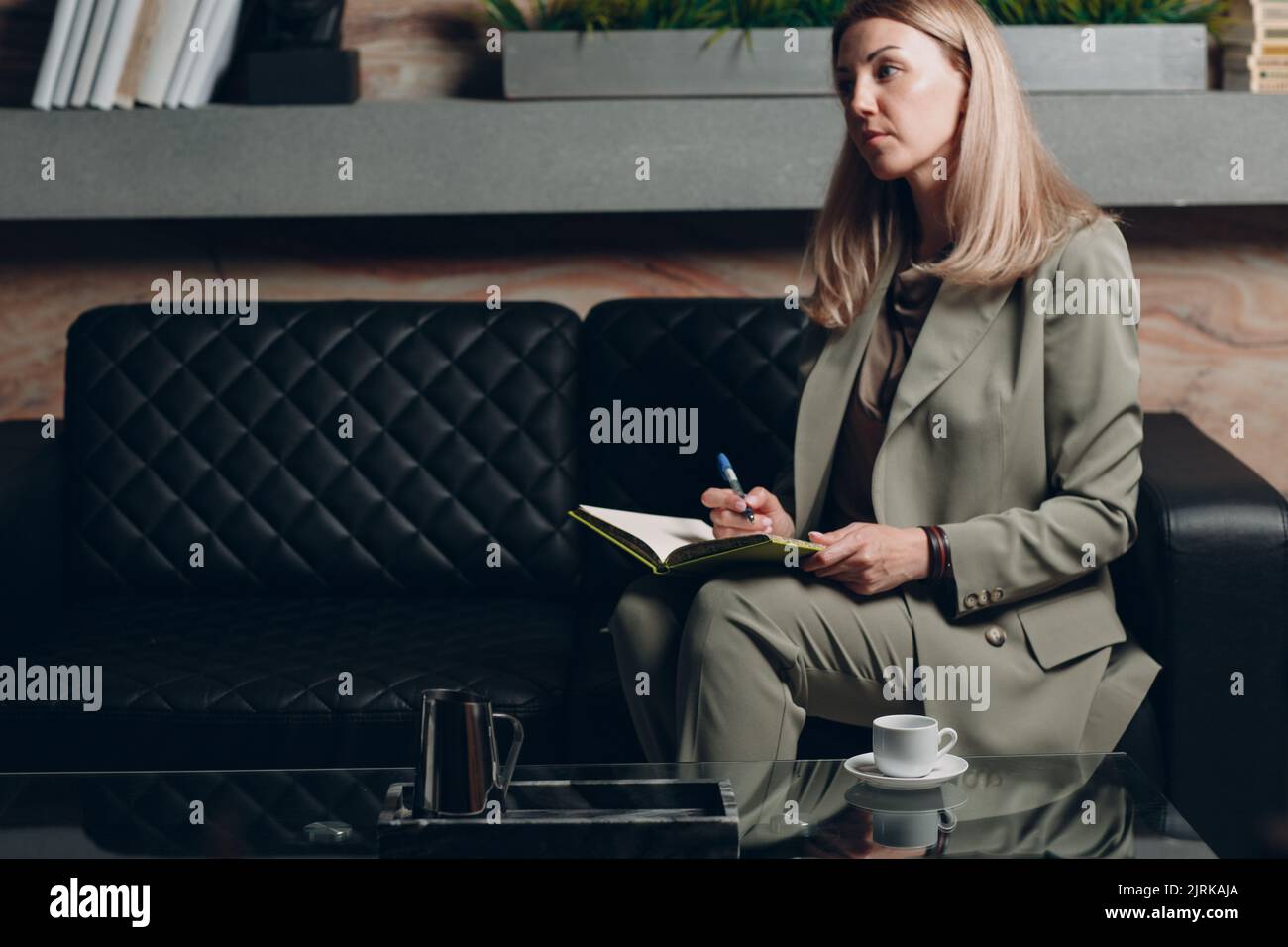 Business woman young adult coach sitting with notebook book at office ...