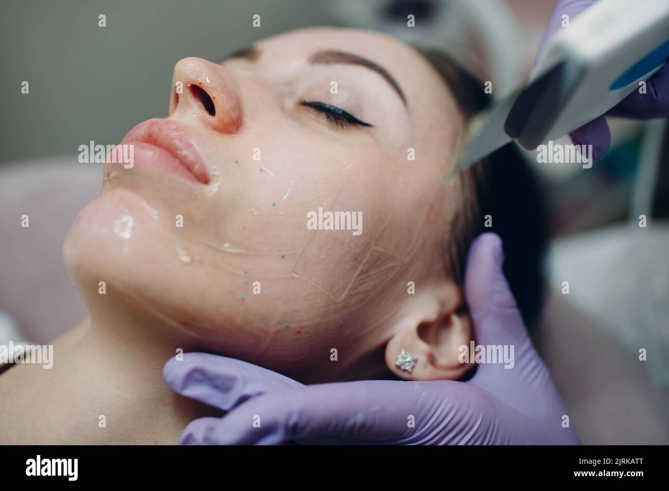 Woman receiving cleansing therapy with a professional ultrasonic ...